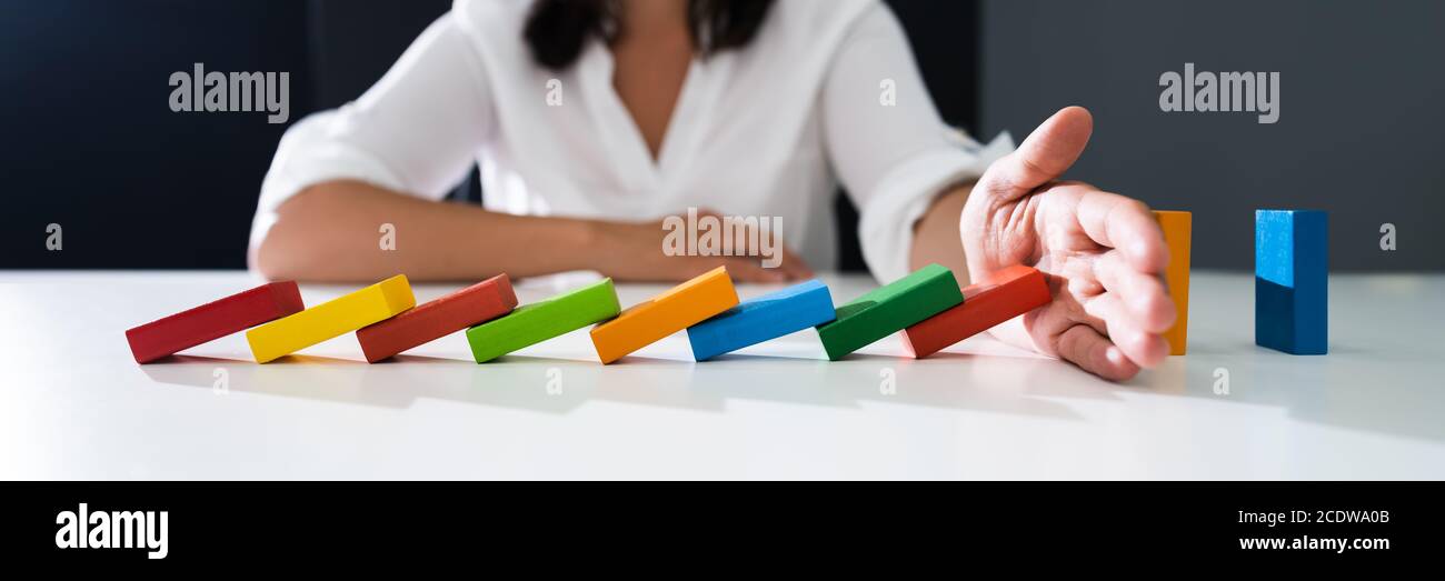 Domino Game Risk Stop. Prevent Fall. Chain Effect Stock Photo - Alamy