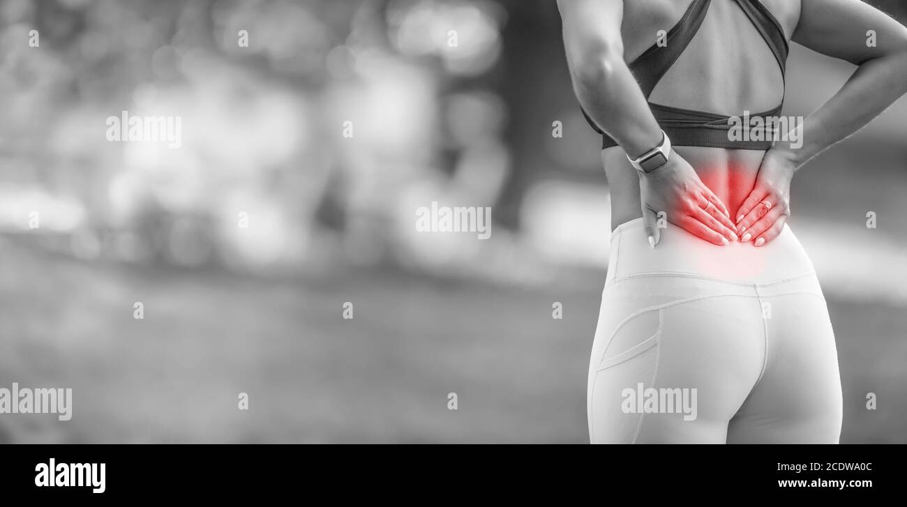 Back pain during sports. Young woman with an athletic figure and a ...