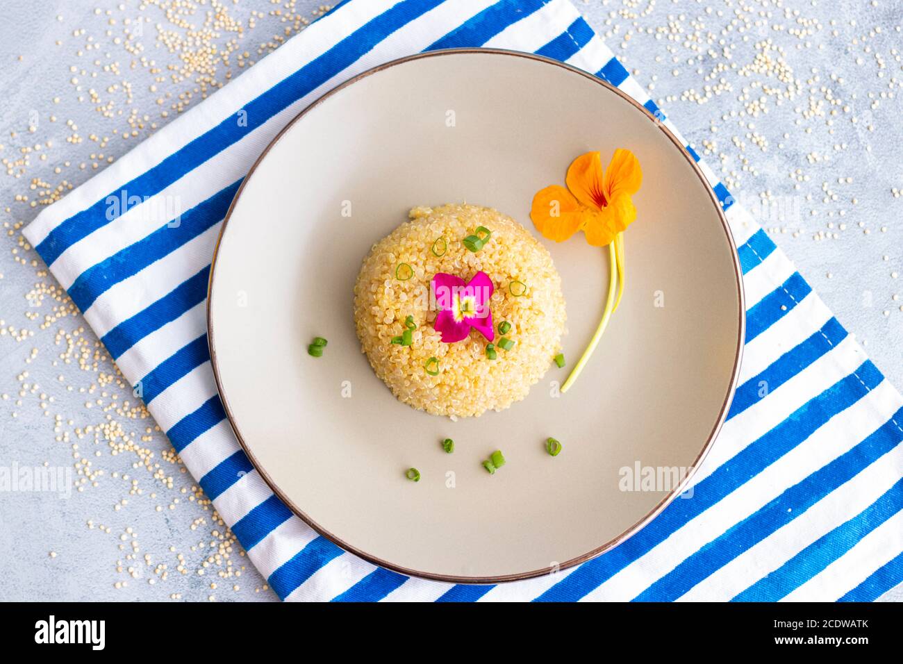 Quinoa plate presentation decorated with edible flowers Stock Photo - Alamy