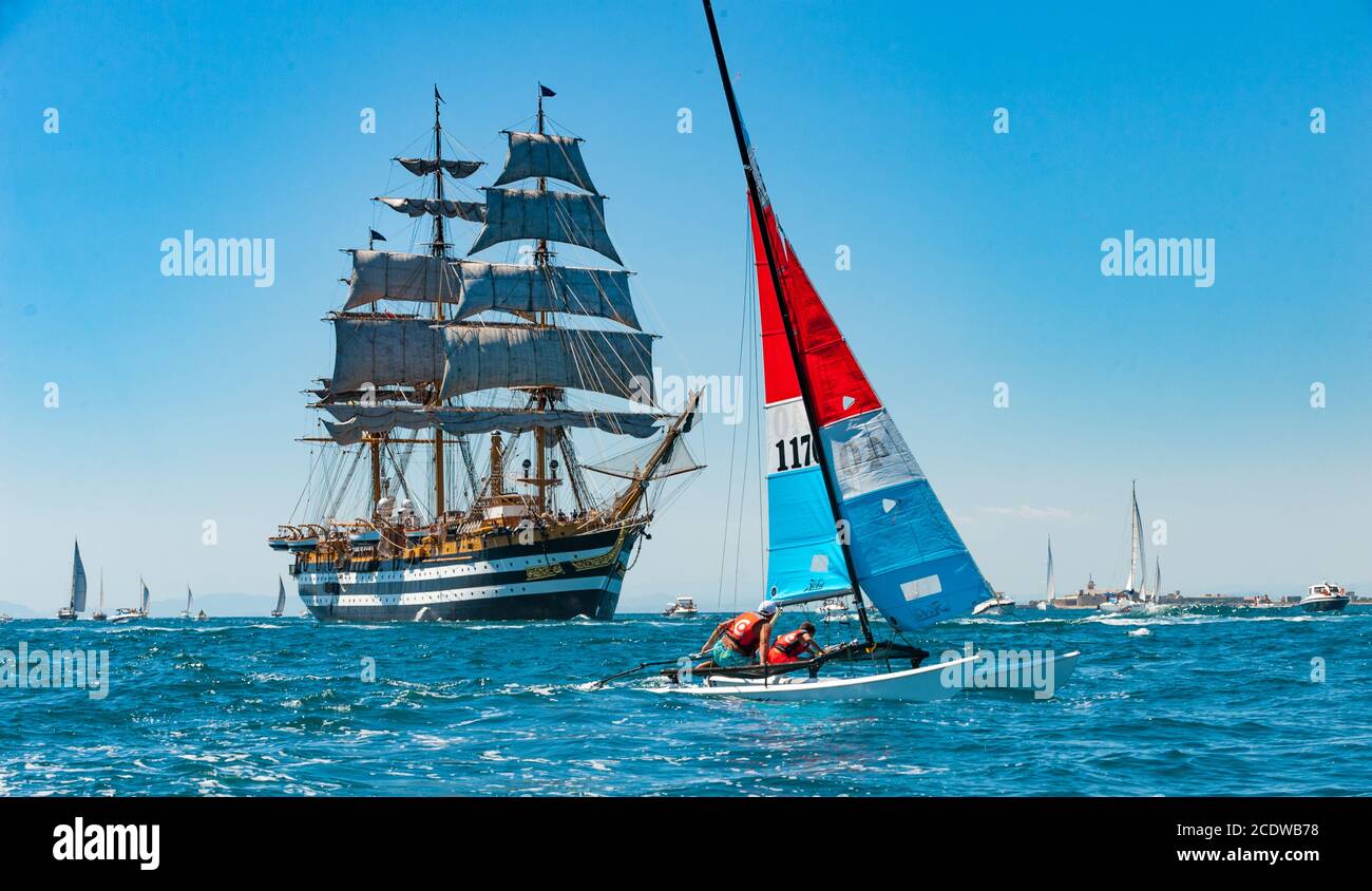 Hobie cat sail boat welcoming the training ship of the Italian Navy ...