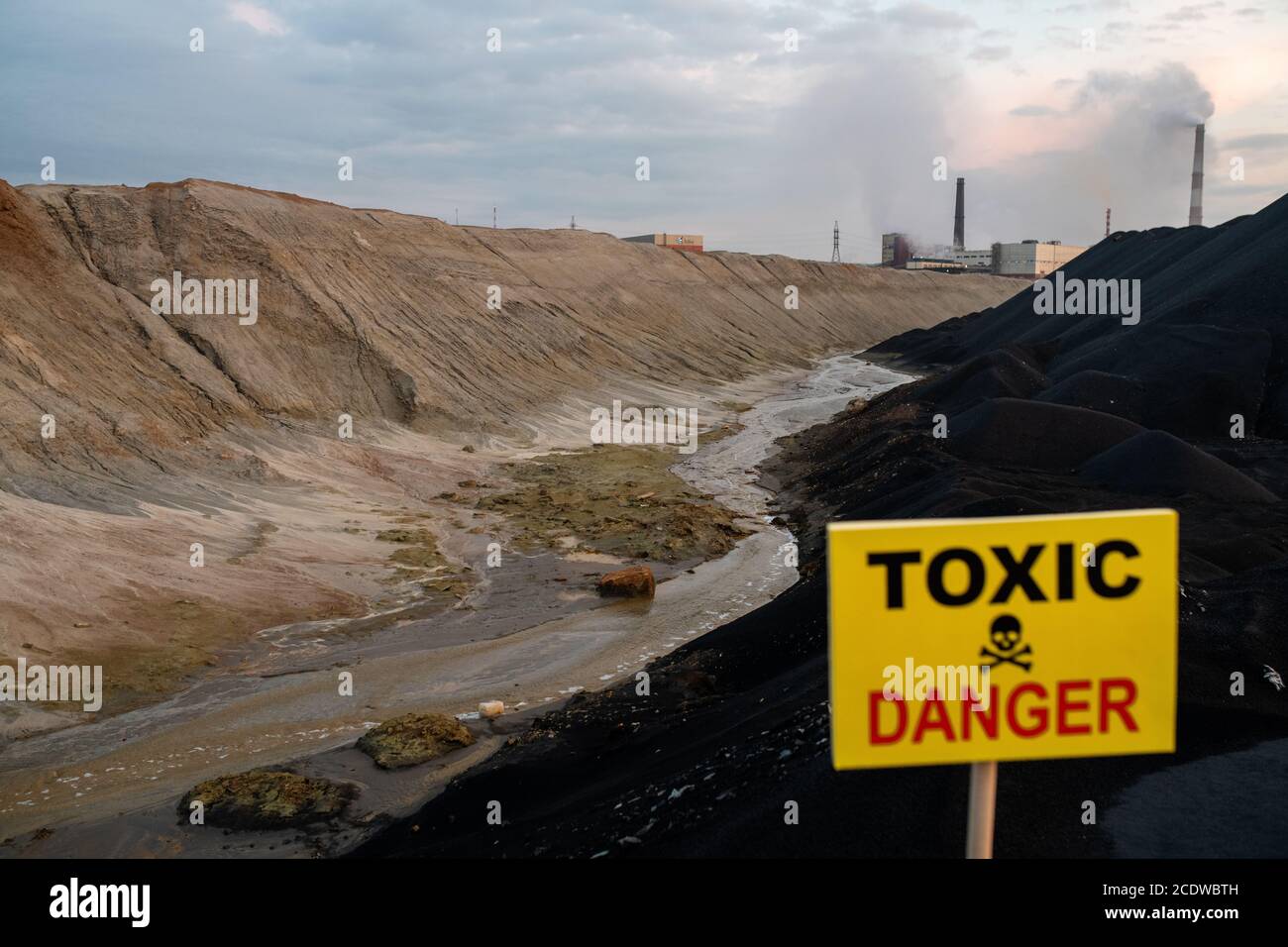 Notice on rectangular yellow board announcing about toxic and dangerous ...