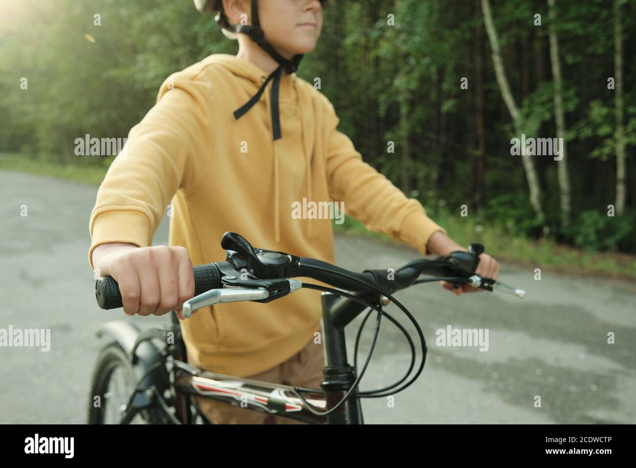 Boy pushing bicycle hi-res stock photography and images - Alamy