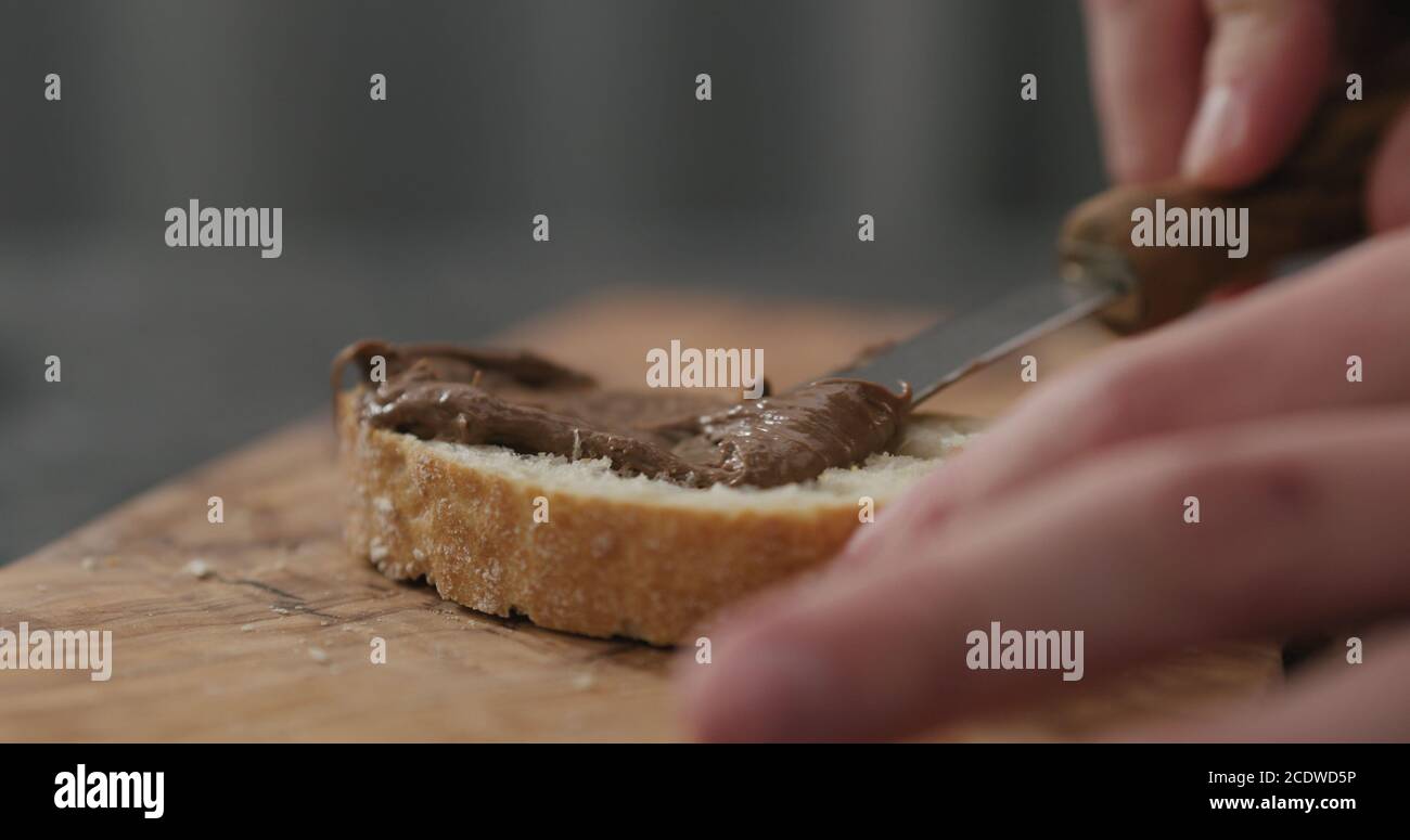 Hands spreading chocolate cream on hi-res stock photography and images ...