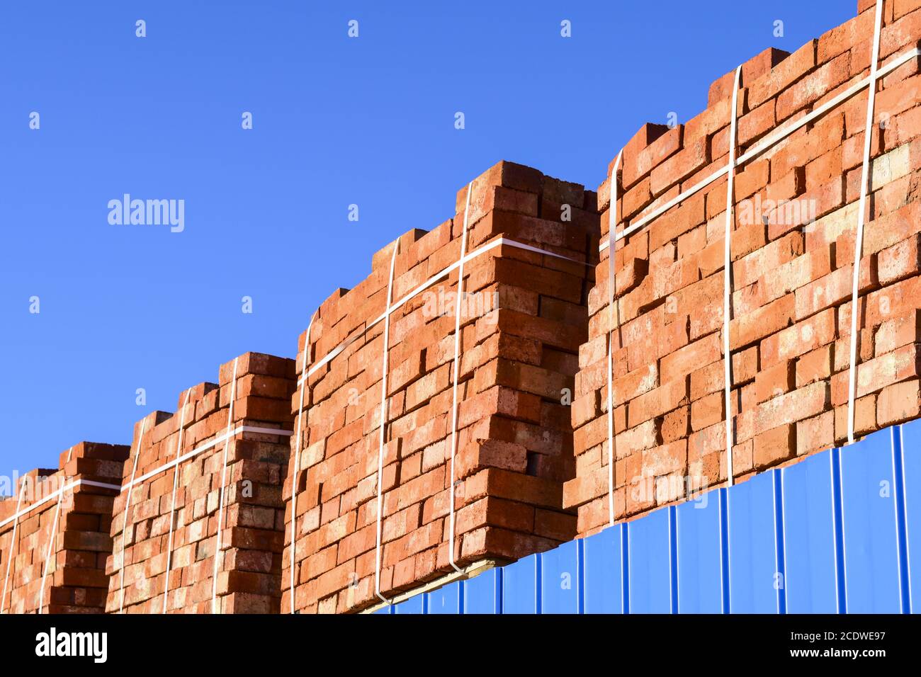 Red bricks stacked into cubes. Warehouse bricks. Storage brickworks ...