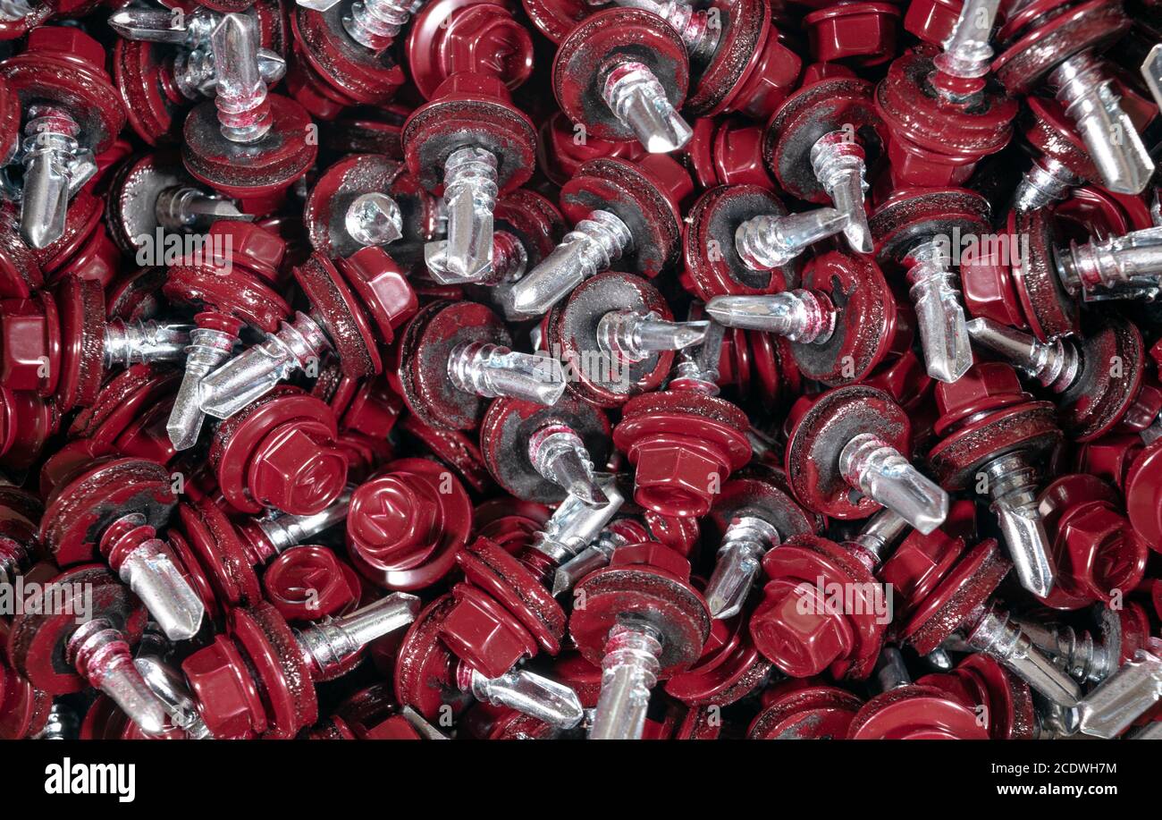 Top view of roofing screws background texture. Red roofing screws ...