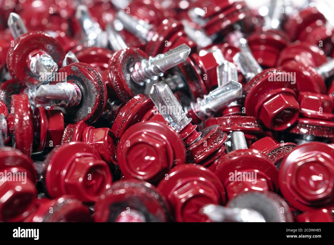 Macro shot of a view of roofing screws background texture. Red roofing ...