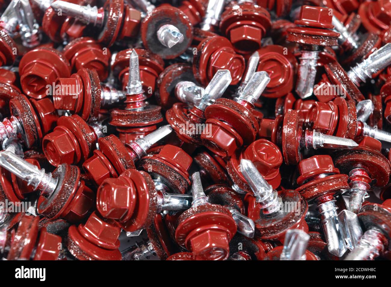 Top view of roofing screws background texture. Red roofing screws ...