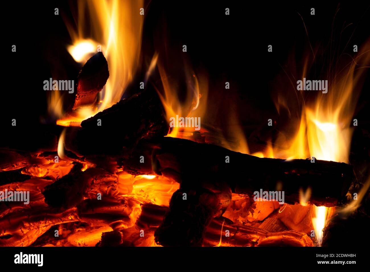 Burning wood logs in the fireplace close up. Barbeque fire. Charcoal ...