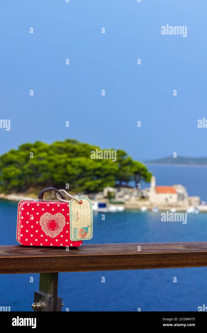 Little red suitcase on travel Stock Photo - Alamy