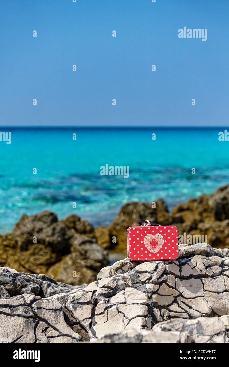 Little red suitcase on travel Stock Photo - Alamy