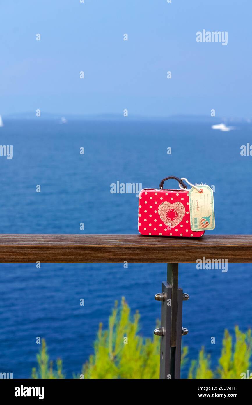 Little red suitcase on travel Stock Photo - Alamy