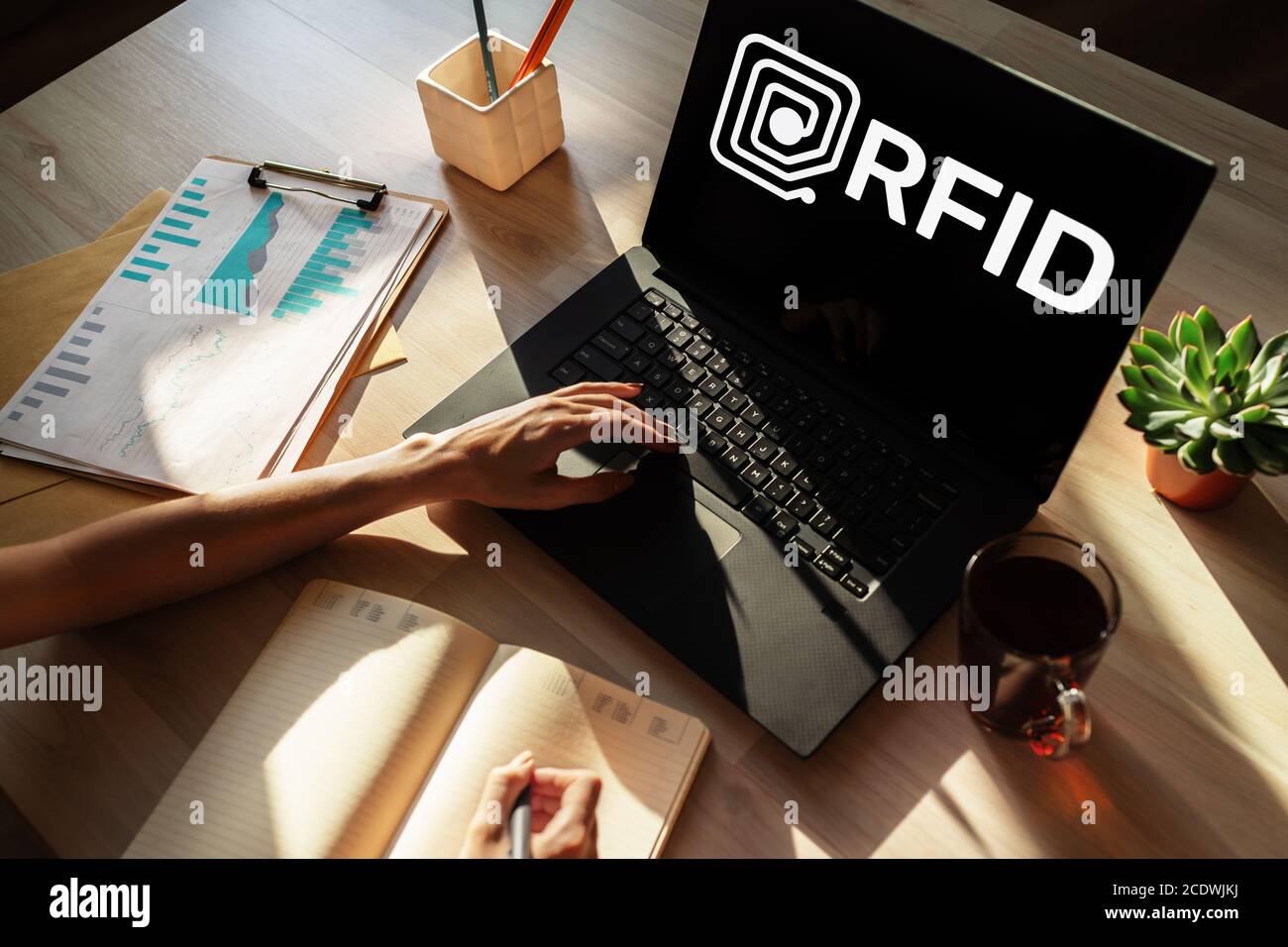 RFID Radio frequency identification technology concept on device screen ...