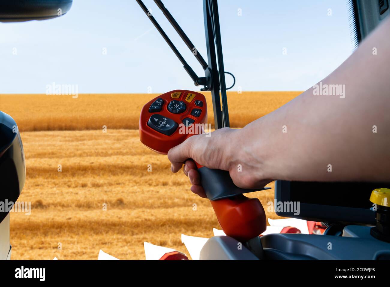 Farmer controls the combine harvester Stock Photo - Alamy