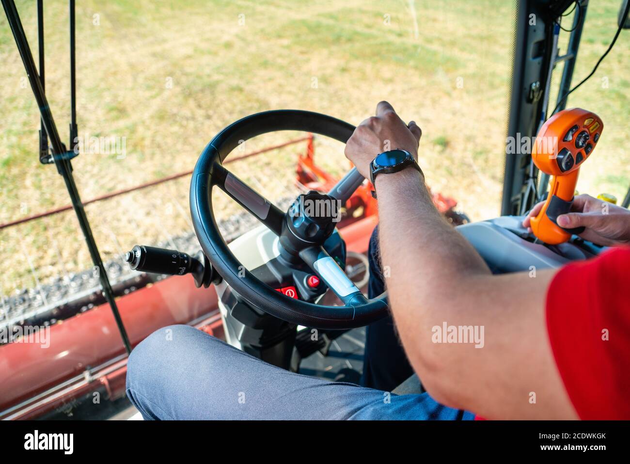 Farmer controls the combine harvester Stock Photo - Alamy