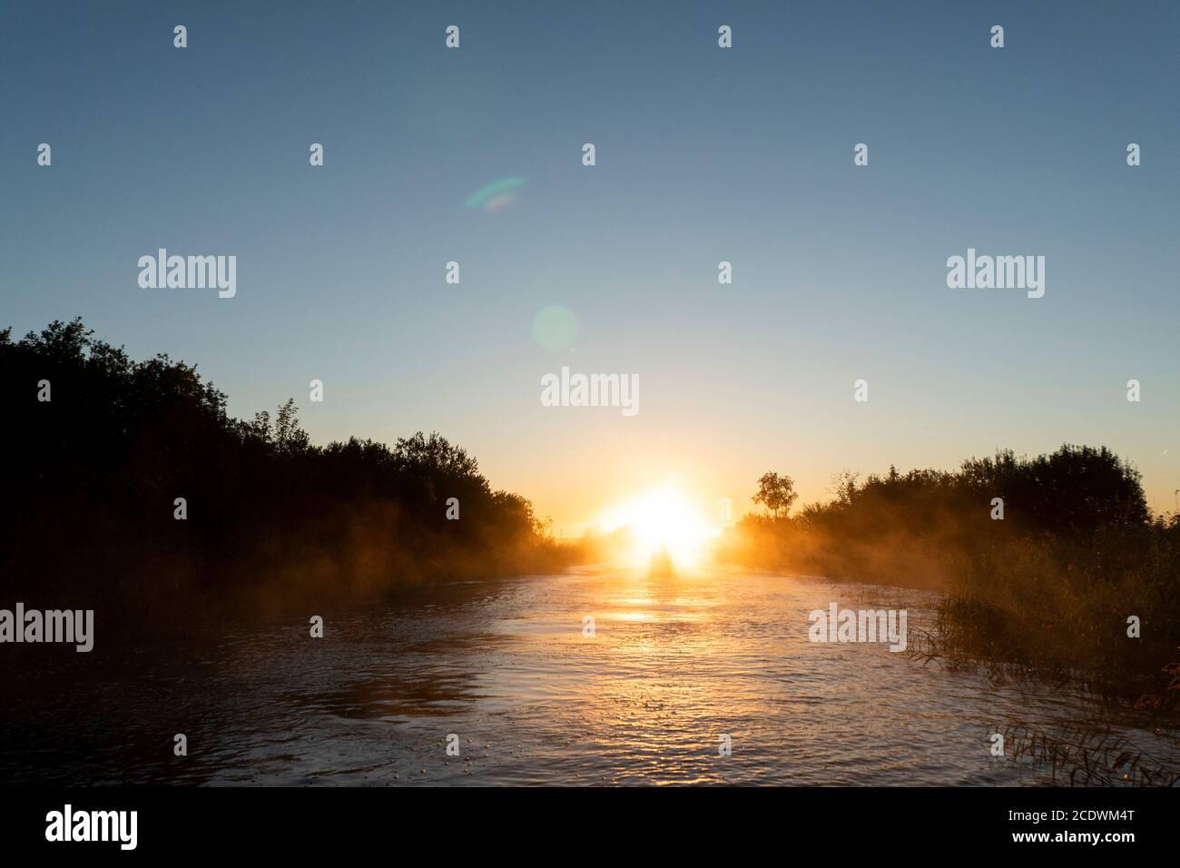 Sunrise sky background. Gold sunrise sky with sky clouds over the lake ...