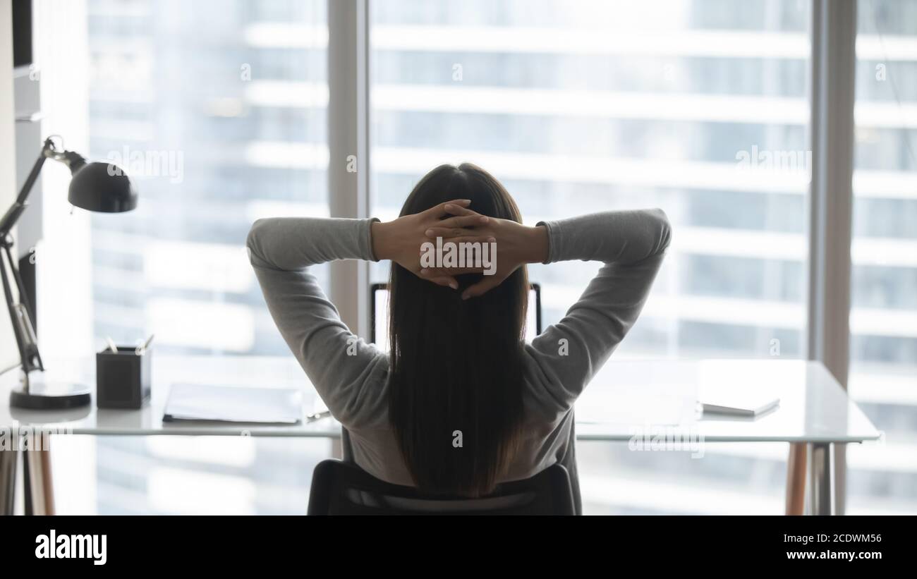 Woman leaning back in chair hi-res stock photography and images - Alamy