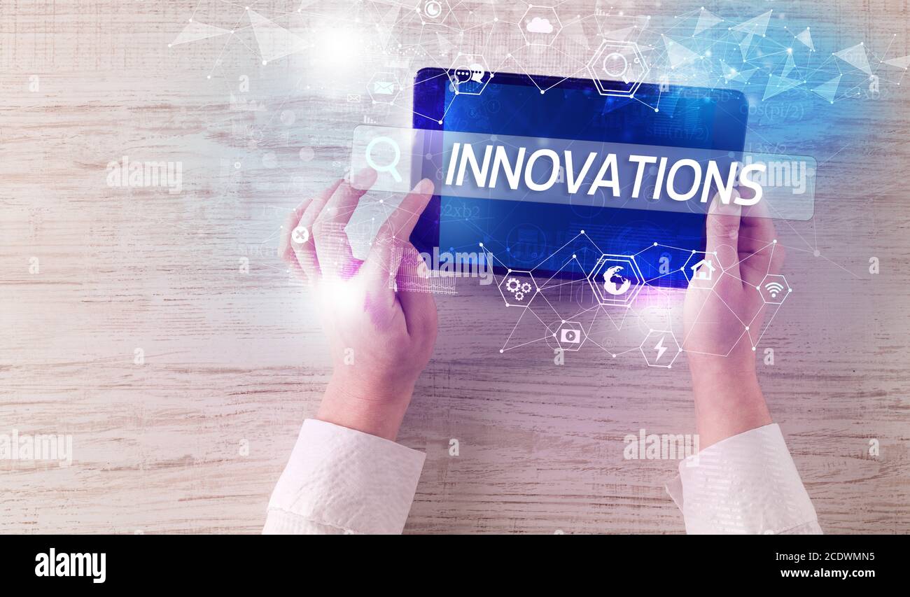 Close-up of a tablet searching INNOVATIONS inscription, hi-tech ...