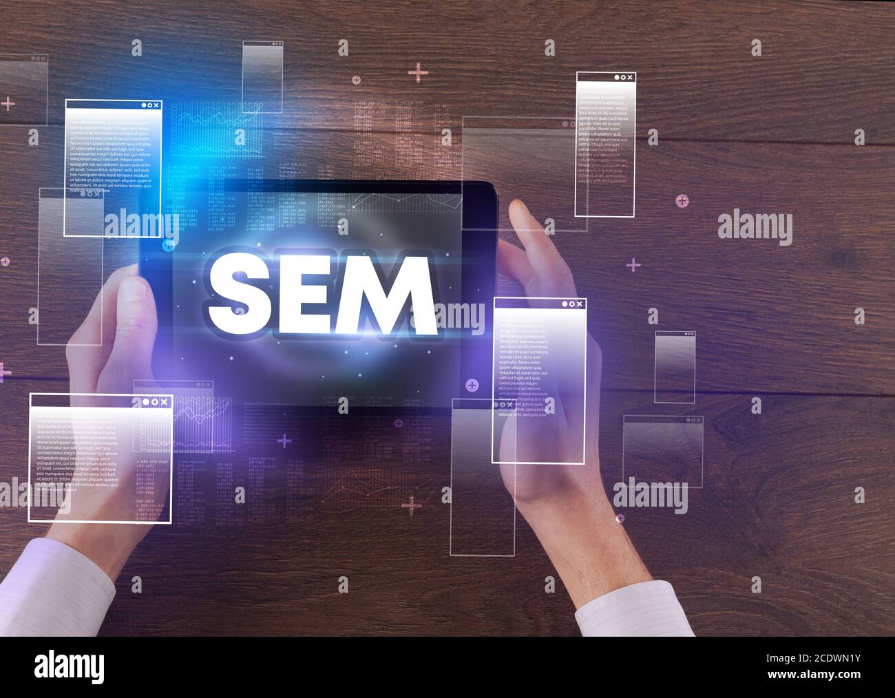 Close-up of a hand holding tablet with SEM abbreviation, modern ...