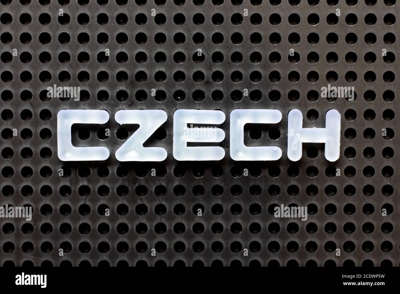 White color alphabet with word czech on black pegboard background Stock ...