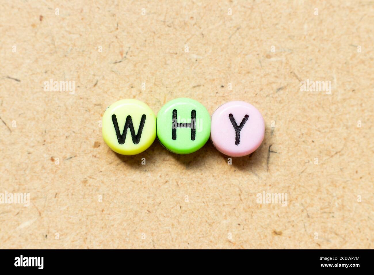 Round color bead with black letter in word why on wood background Stock ...