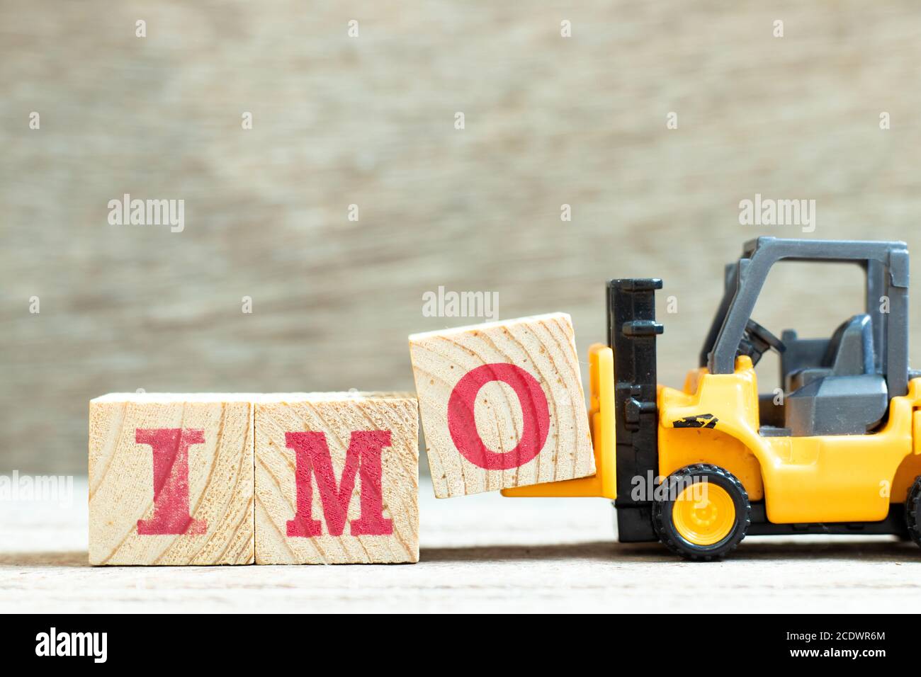 Toy forklift hold letter block o to complete word IMO (Abbreviation of ...