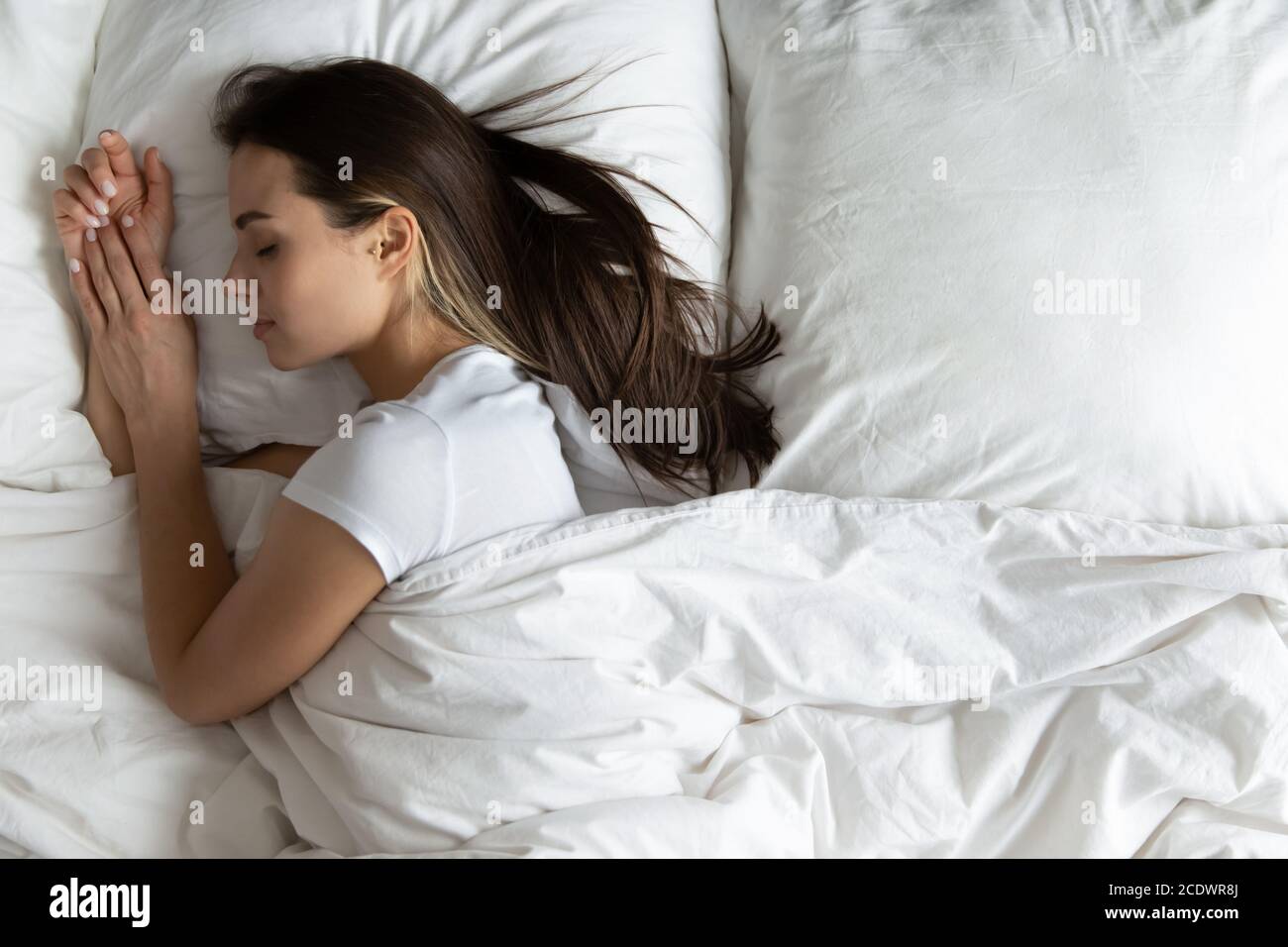 Top view peaceful young woman sleeping on side in bed Stock Photo - Alamy