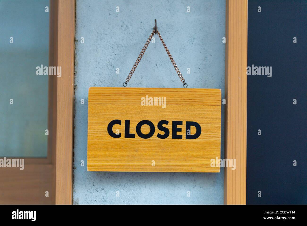 Closed sign board hanging on the wall Stock Photo - Alamy