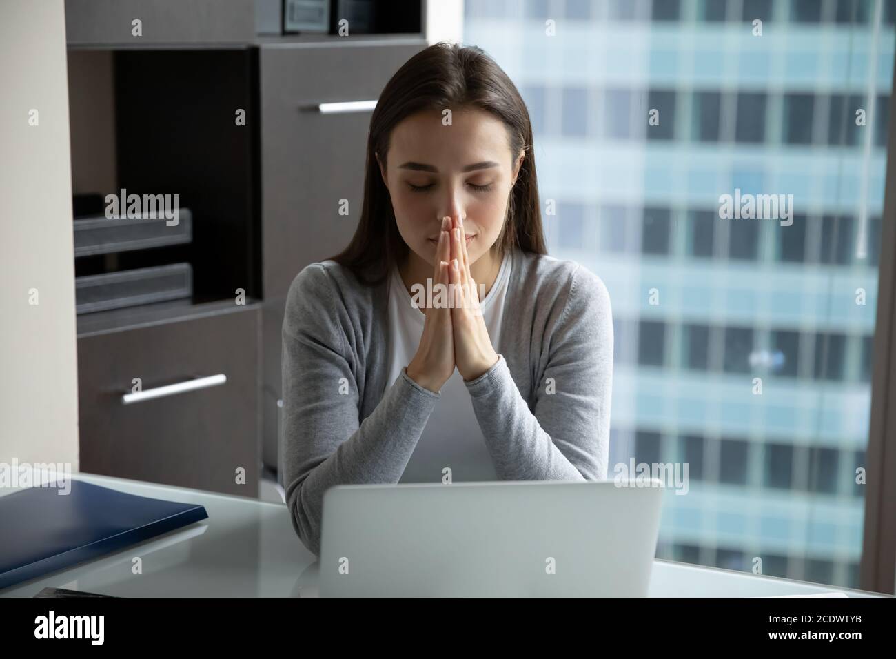 Woman employee praying hi-res stock photography and images - Alamy