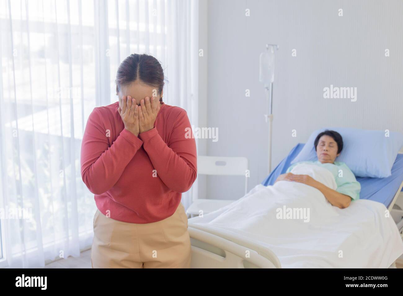 An Asian woman cries and sorrows beside the hospital bed Stock Photo ...
