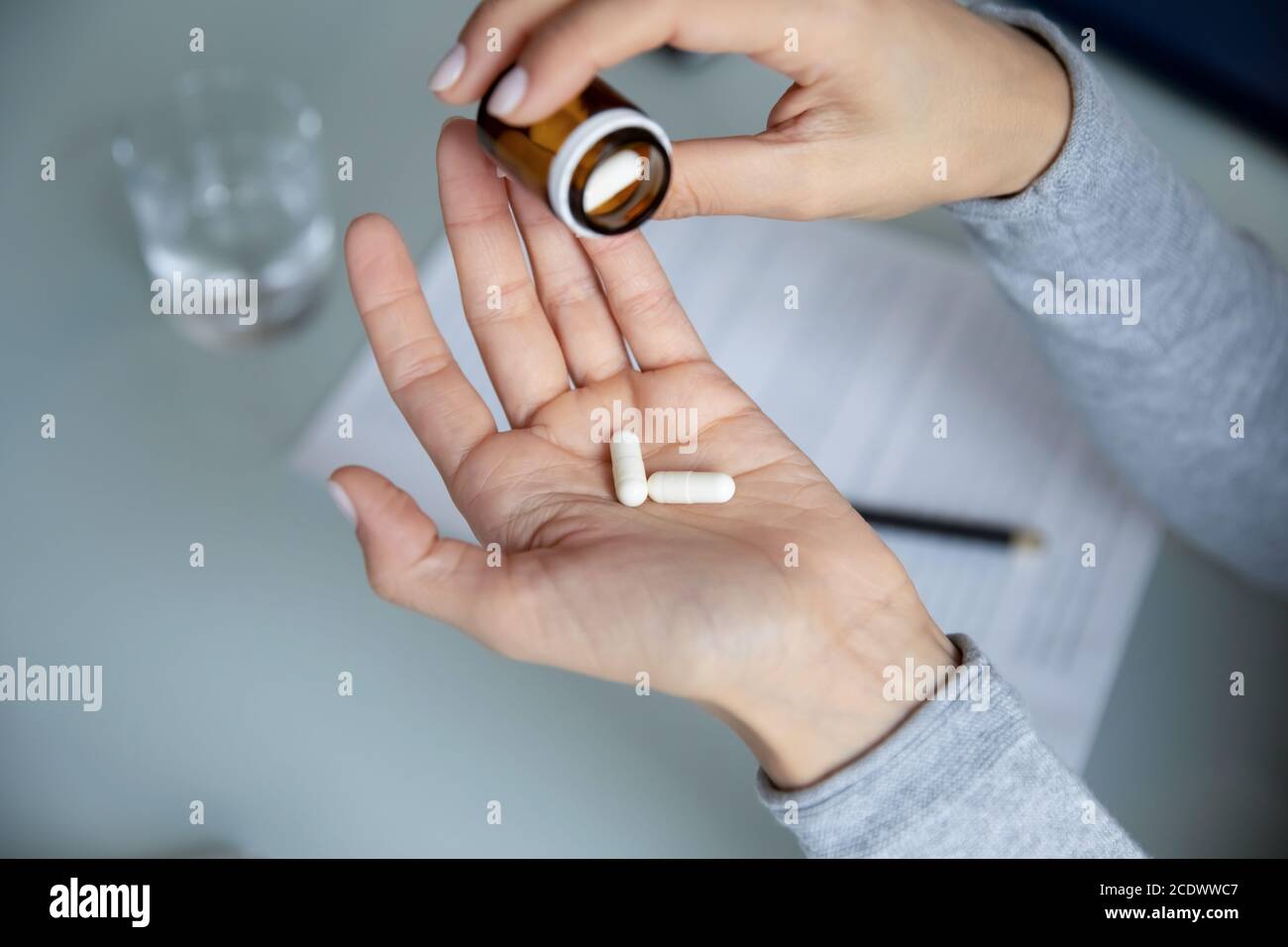 Close up young woman taking out pills from packaging Stock Photo - Alamy