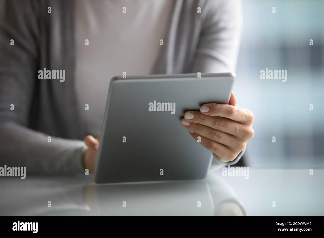 Close up young businesswoman holding computer tablet, browsing apps ...
