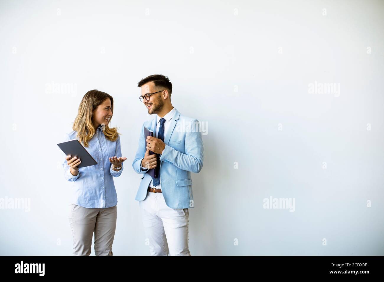 Young people with digital tablet by the wall in the office Stock Photo ...