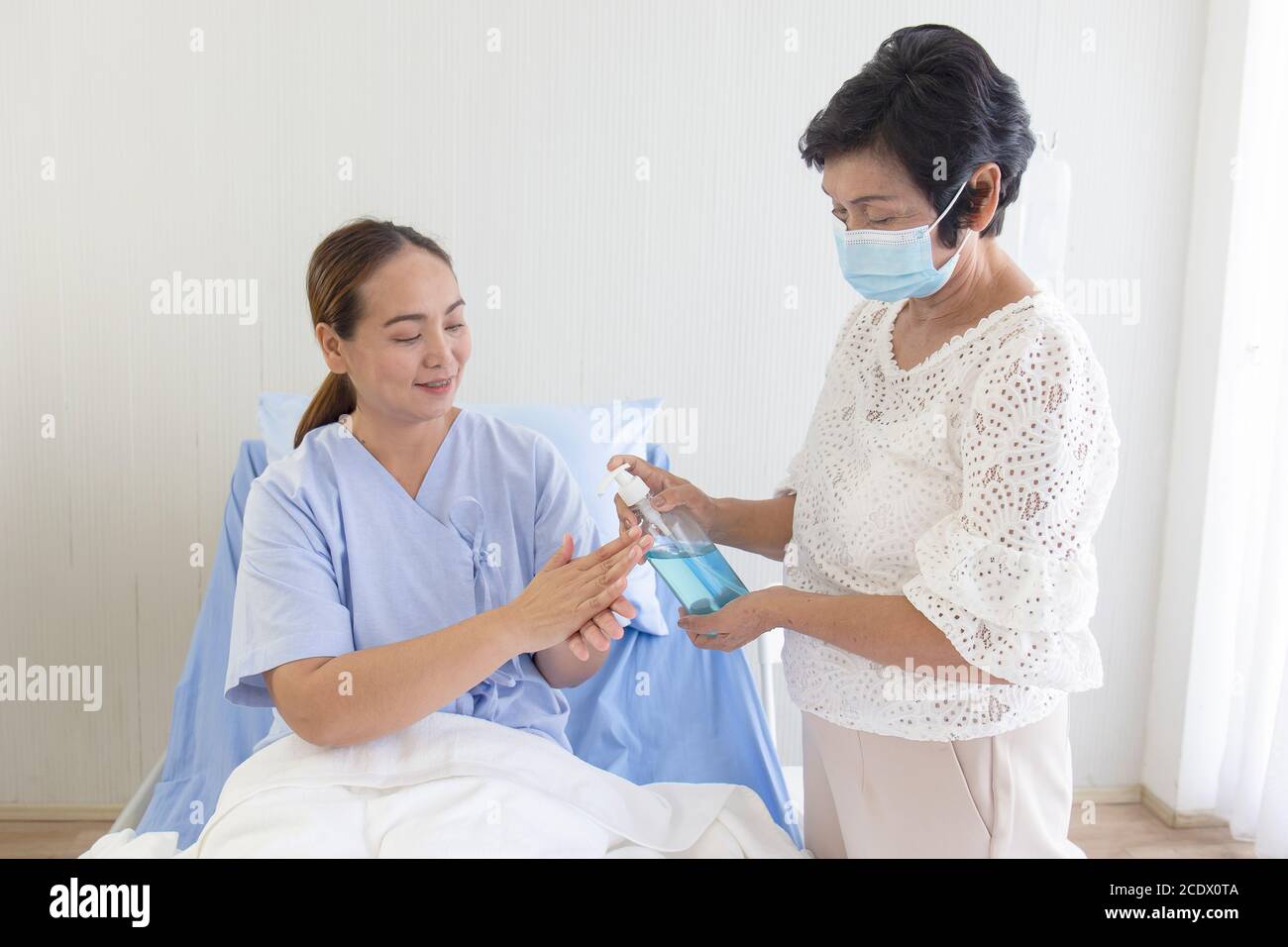Using hand gel hi-res stock photography and images - Alamy