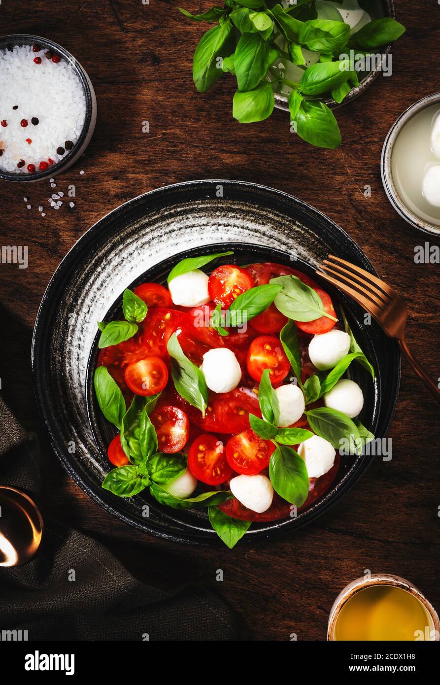 Caprese salad with ripe red tomatoes and mozzarella cheese with fresh ...