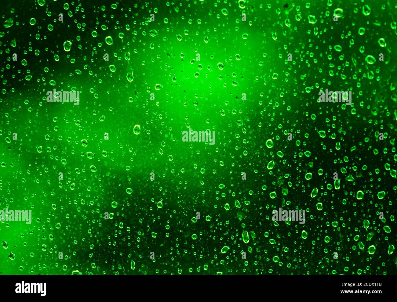 Natural green background with rain drops on the glass Stock Photo - Alamy