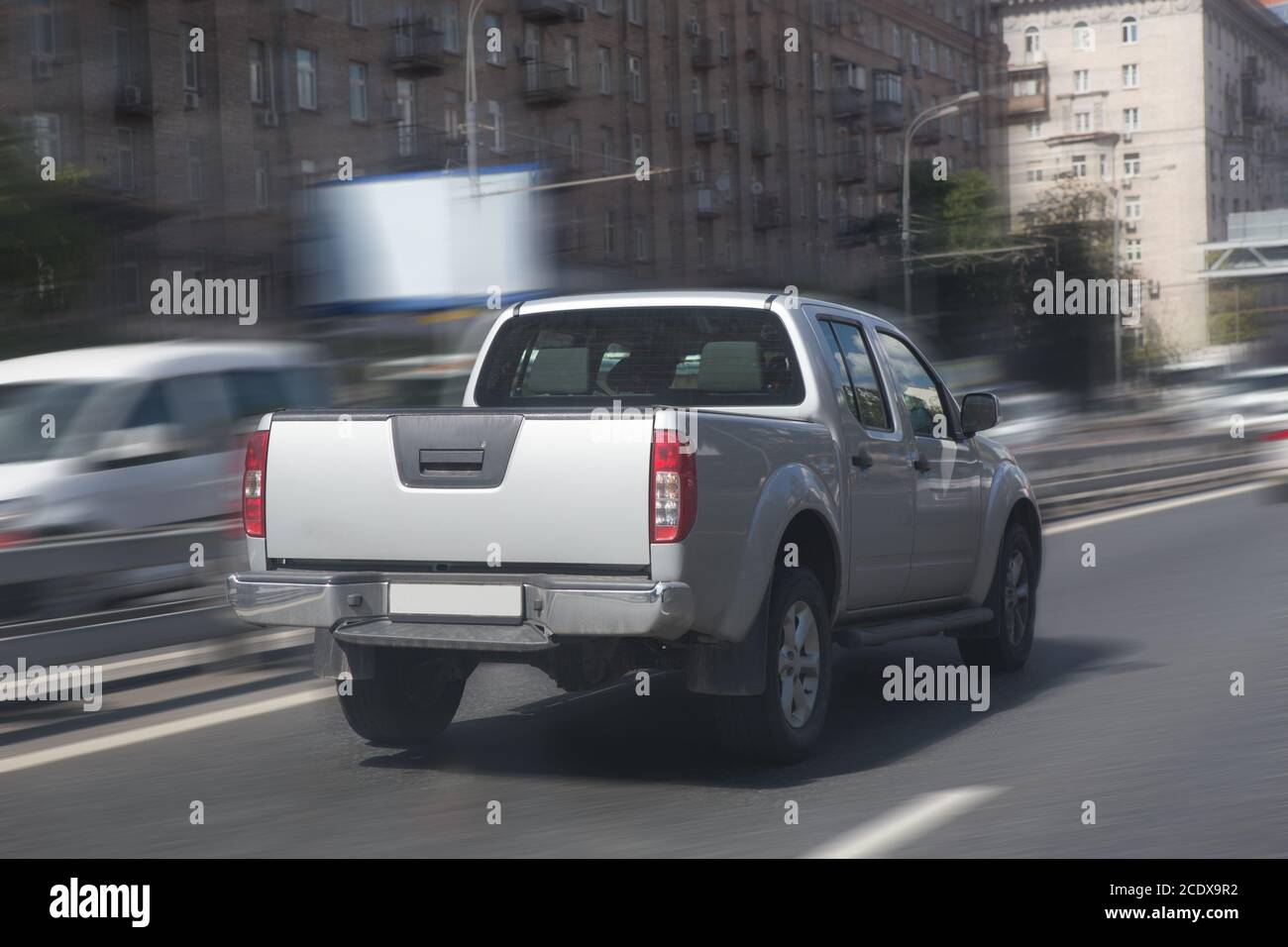 pickup goes on the highway in city Stock Photo - Alamy