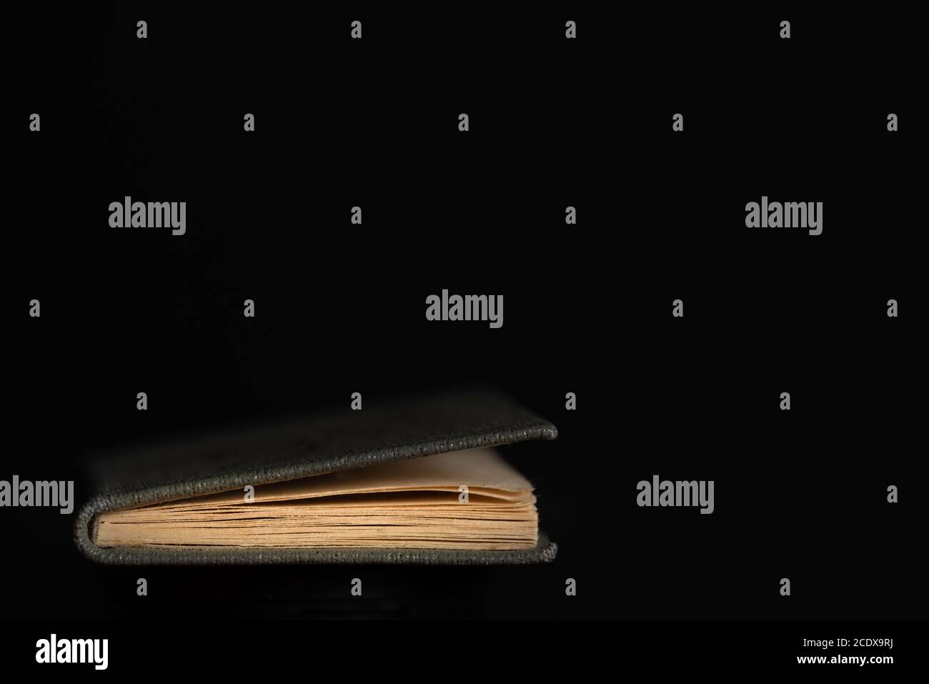 Single old book edge with Gray paper cover, isolated on black ...