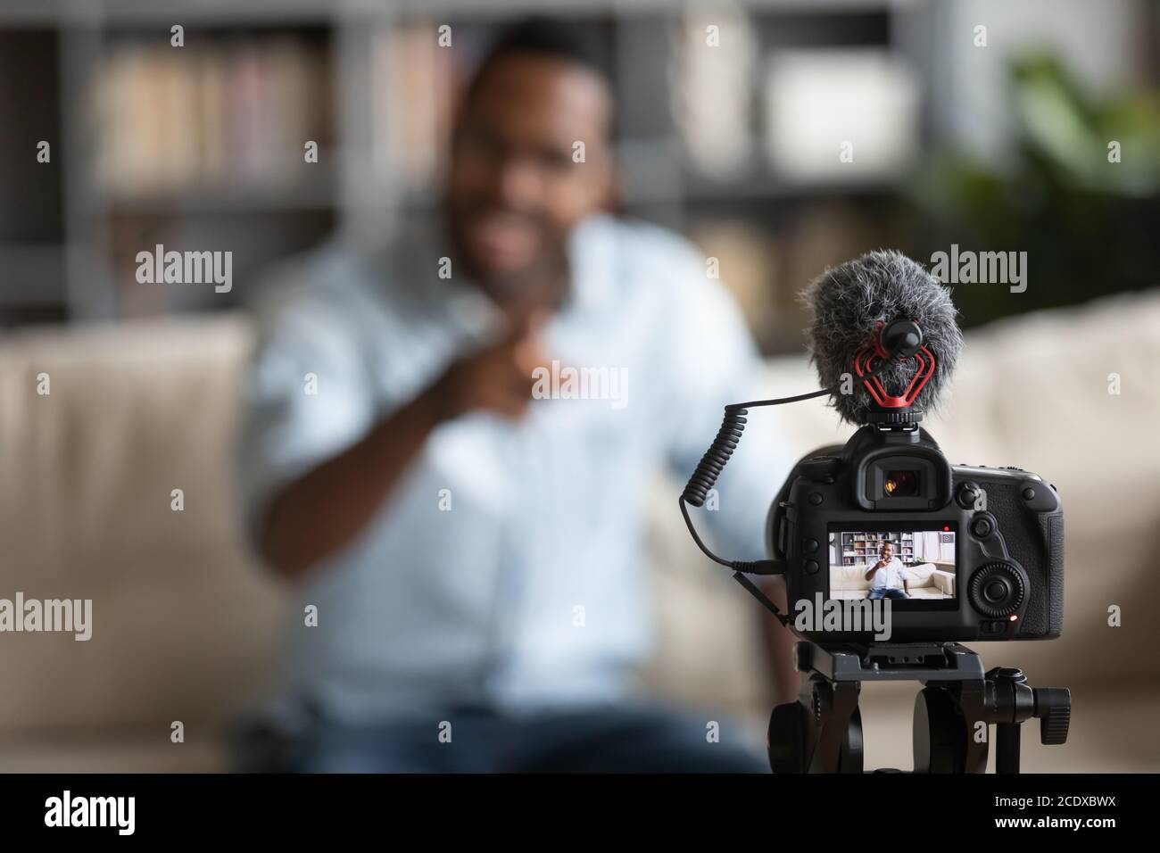 Close up African American blogger using digital camera, recording vlog ...