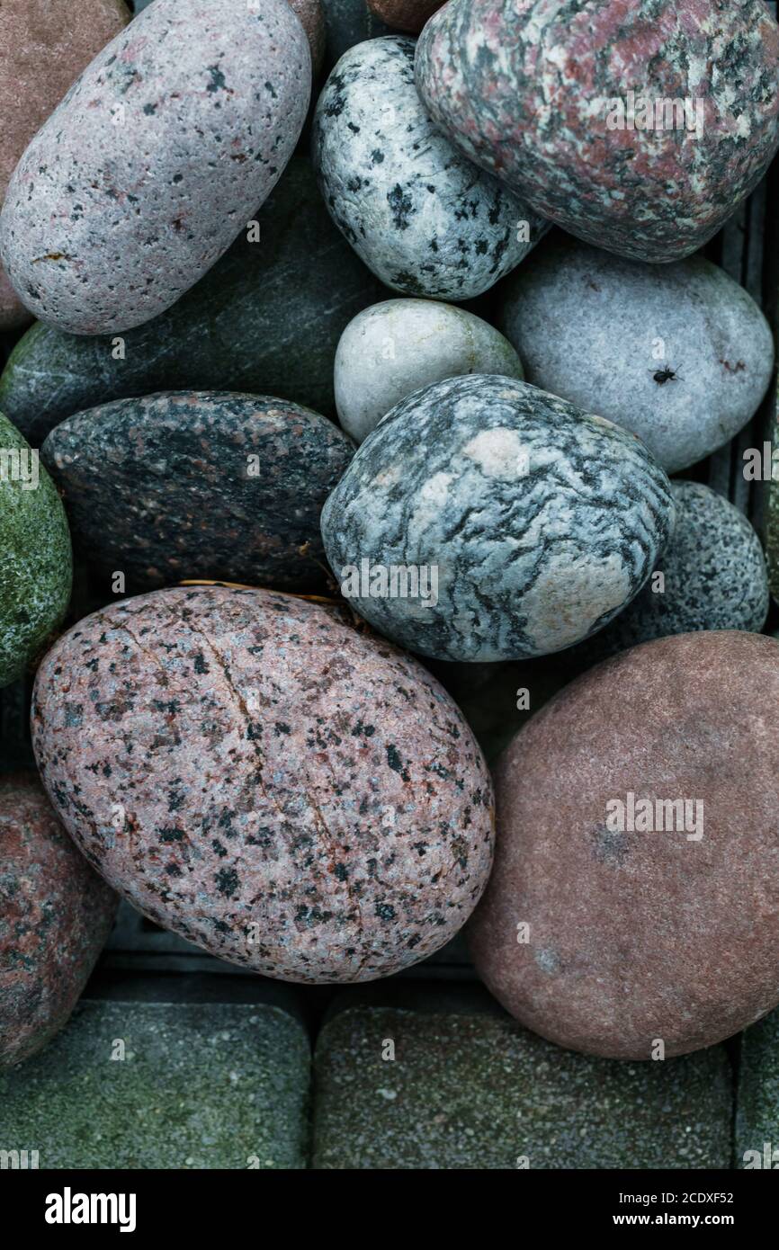 Abstract background with dry round granite stones Stock Photo - Alamy