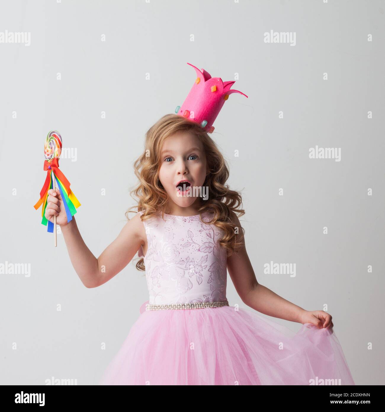 Beautiful excited candy princess girl in crown holding big lollipop ...
