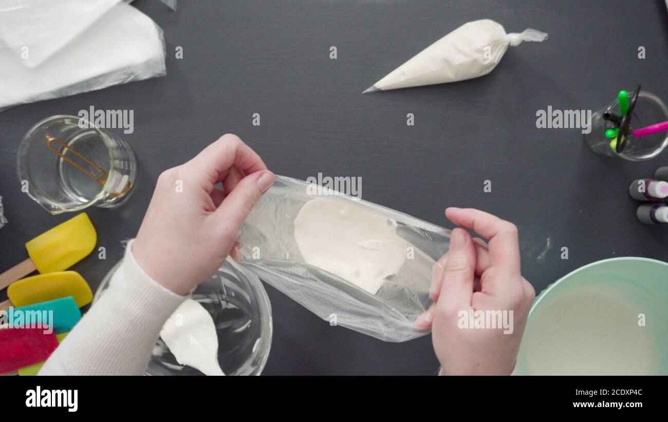 Step by step. Flat lay. Pouring royal icing into the piping bag to ...