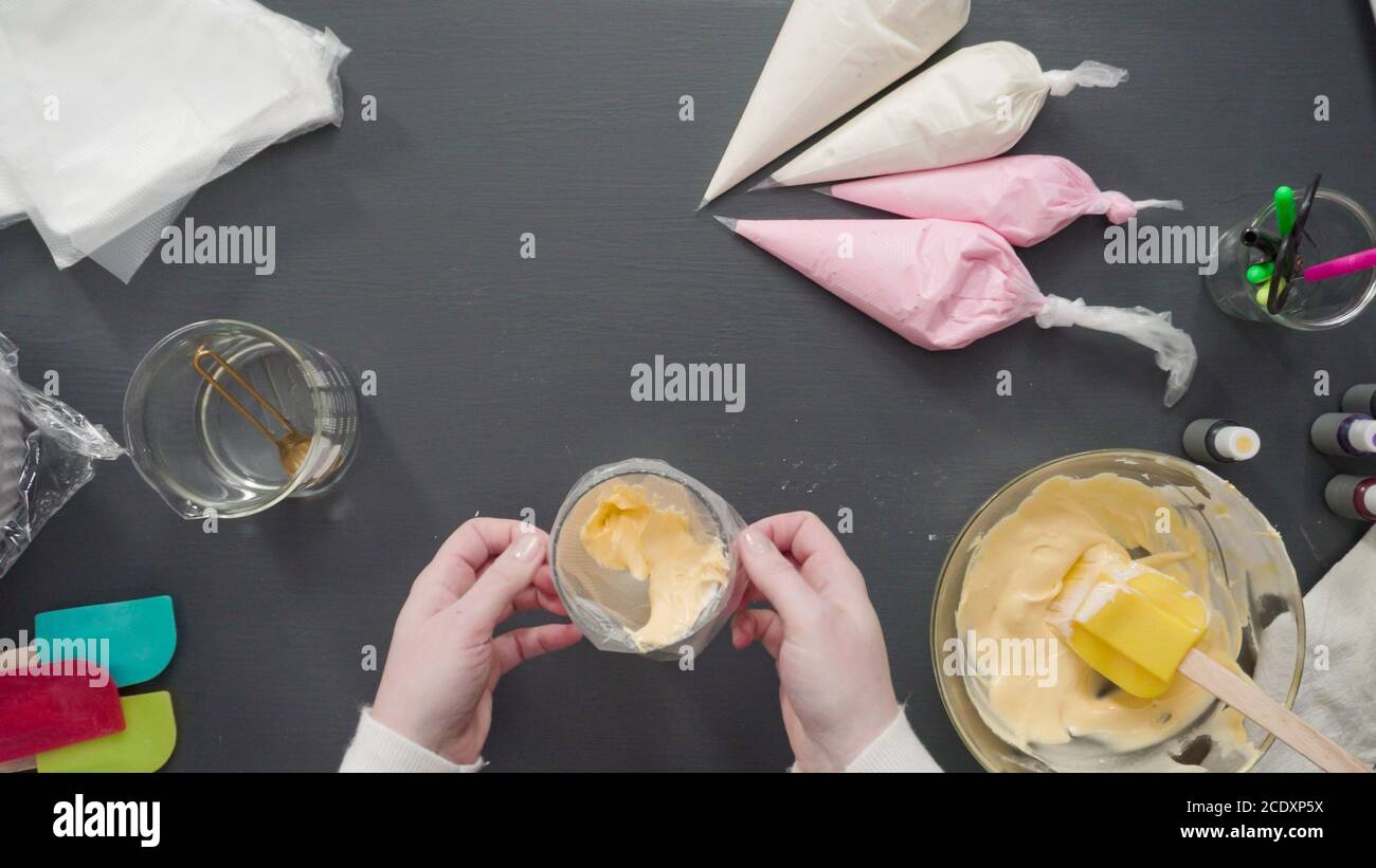 Step by step. Flat lay. Pouring royal icing into the piping bag to ...