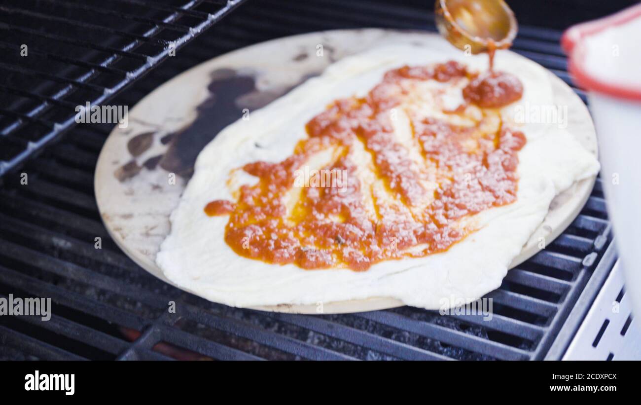 Cooking pizza on outdoor gas grill Stock Photo - Alamy