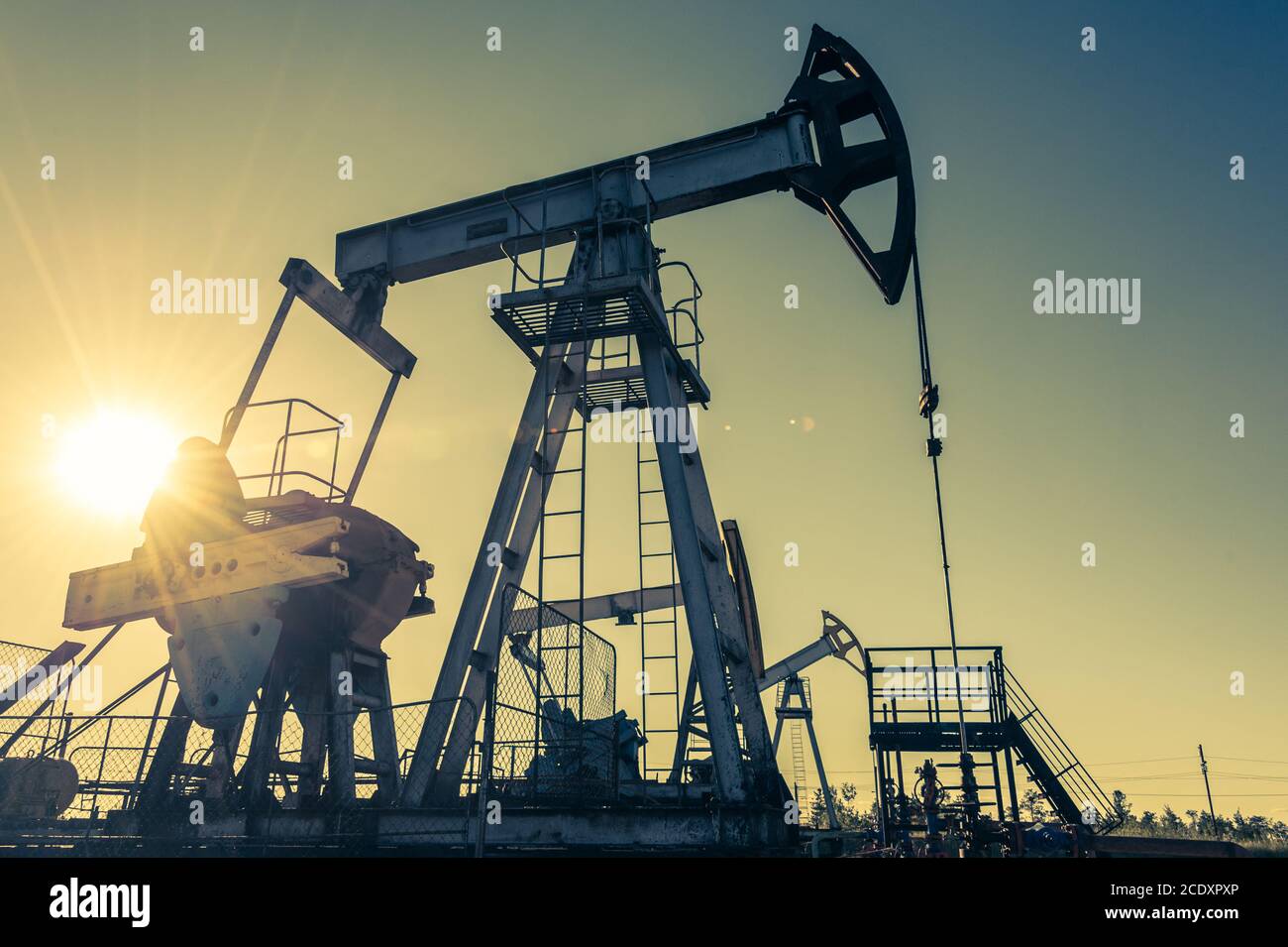 Oil pump rig. Oil and gas production. Oilfield site. Pump Jack are ...