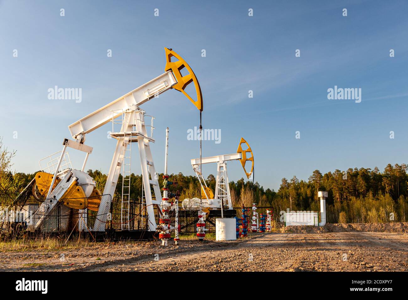 Oil pump rig. Oil and gas production. Oilfield site. Pump Jack are ...