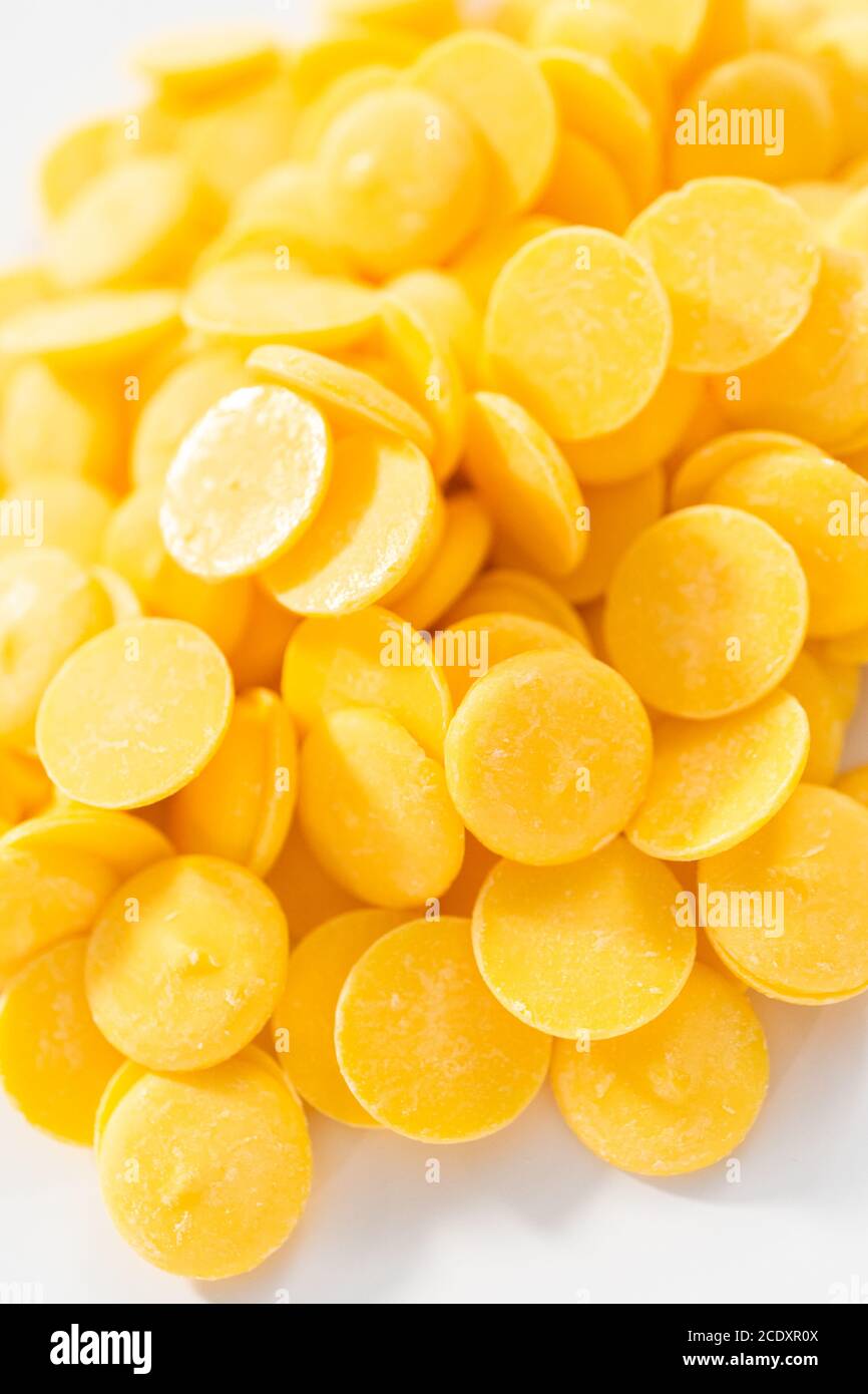 Yellow round chocolate chips for melting chocolate shapes Stock Photo ...