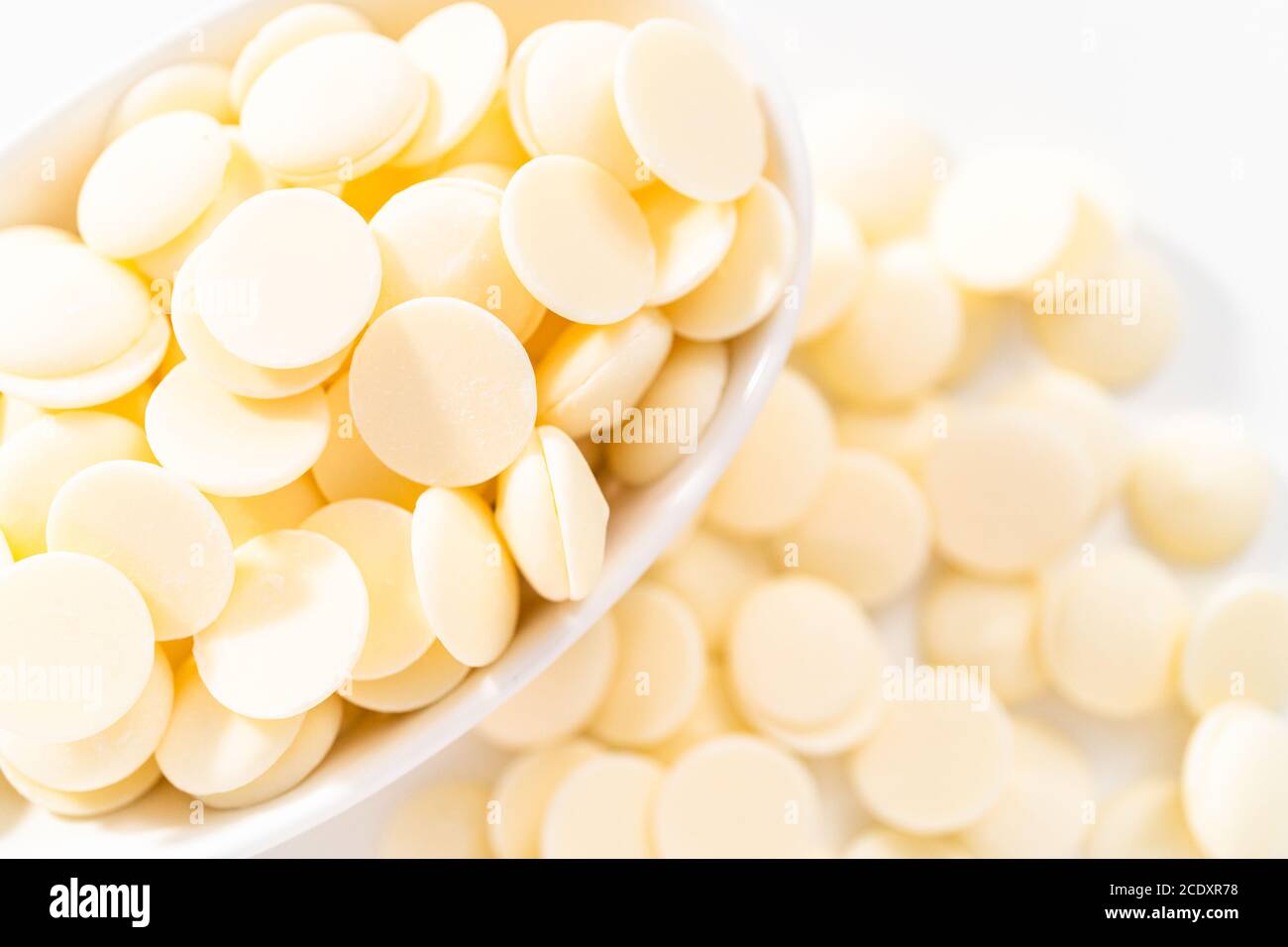 White round chocolate chips for melting chocolate shapes on a white ...