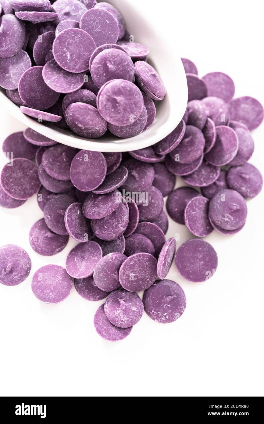 Purple round chocolate chips for melting chocolate shapes on a white ...