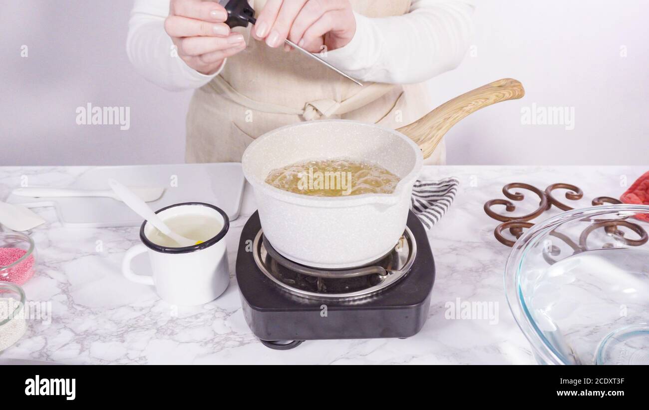Step by step. Caramelizing sugar in a small cooking pot over the small ...