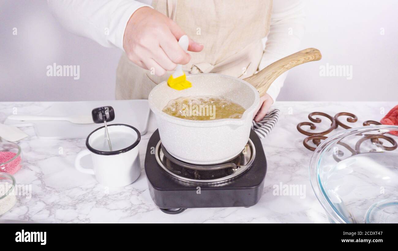 Step by step. Caramelizing sugar in a small cooking pot over the small ...